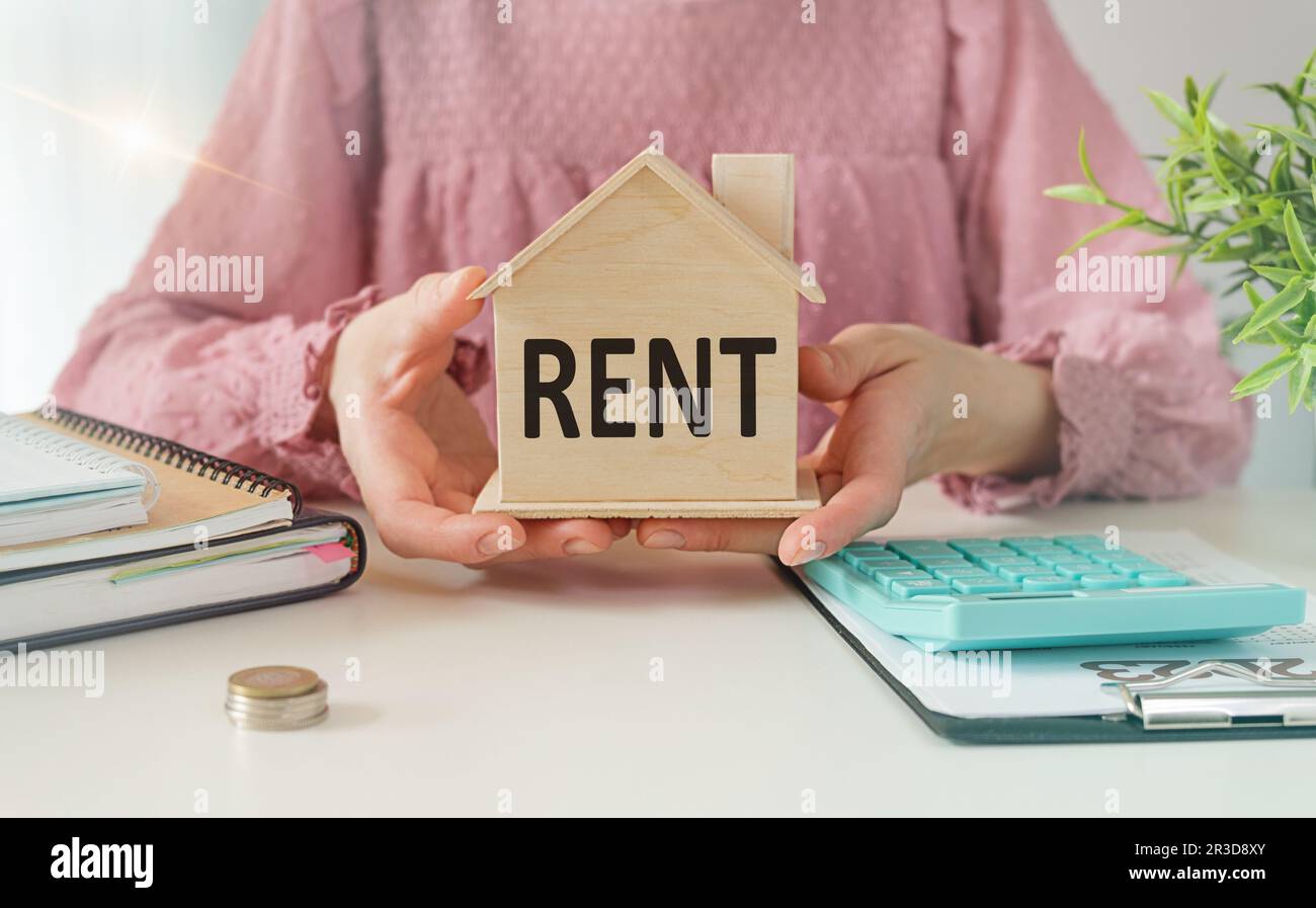 closeup house model with Rent text on desk with banker employee type on ...