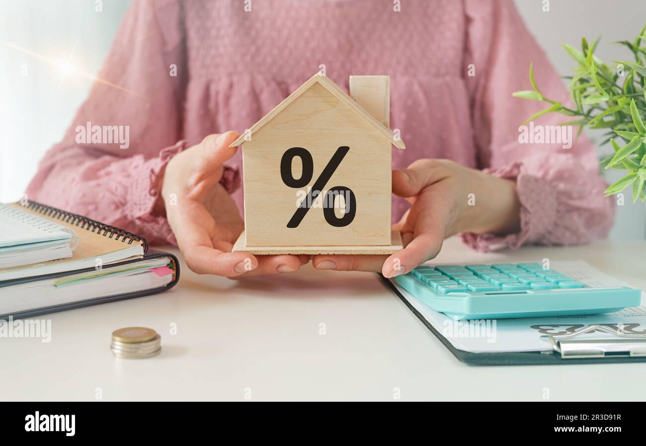 close up house model with percentage of interest rate on table with ...