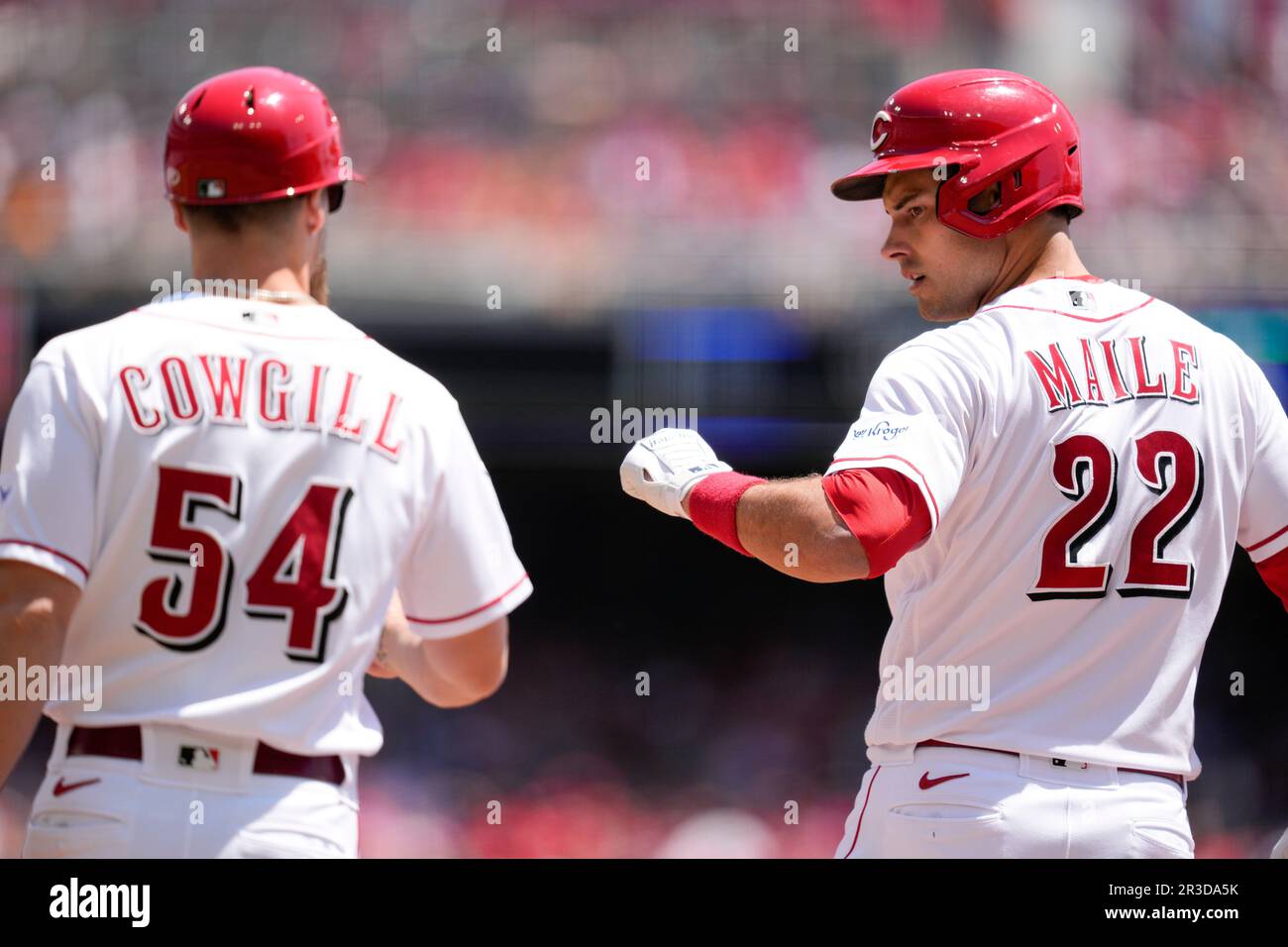 Cincinnati Reds' Luke Maile (22) celebrates with first base coach ...