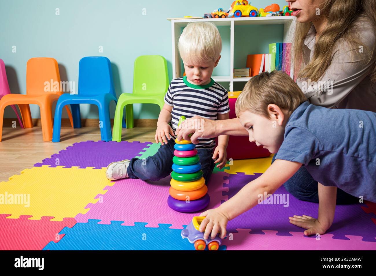 The group of kids in the kindergarten are playing with toys Stock Photo ...