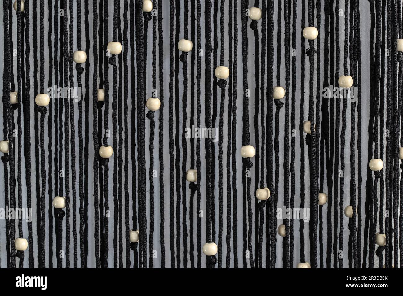 Black strings with beads Stock Photo - Alamy
