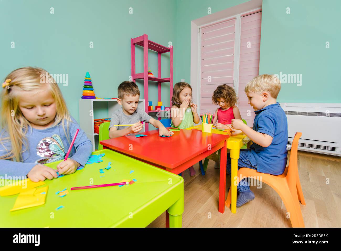 The kids create bright things together in the kindergarten Stock Photo - Alamy