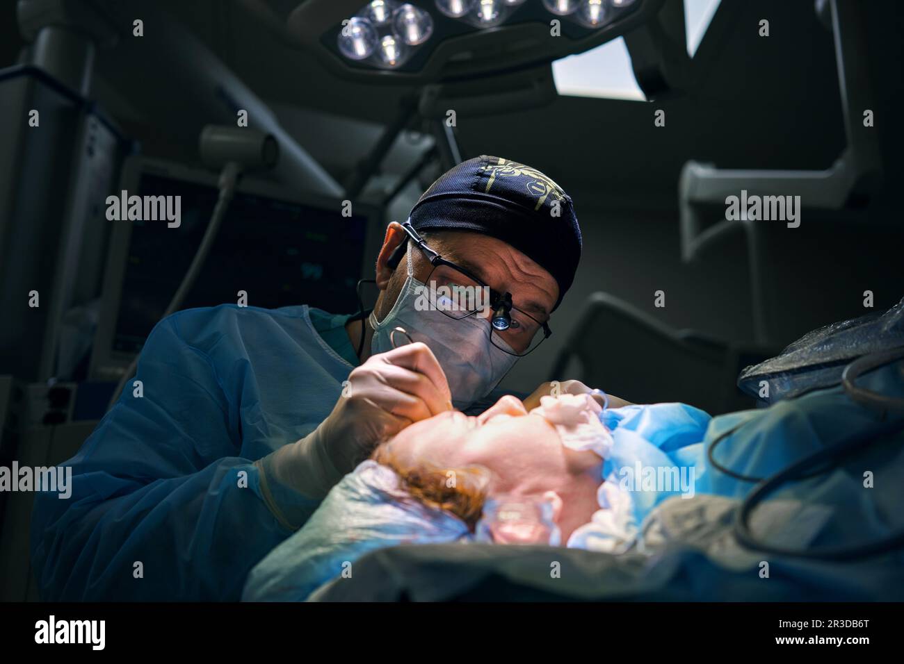 surgeon works in the operating room by the light of a lamp Stock Photo - Alamy
