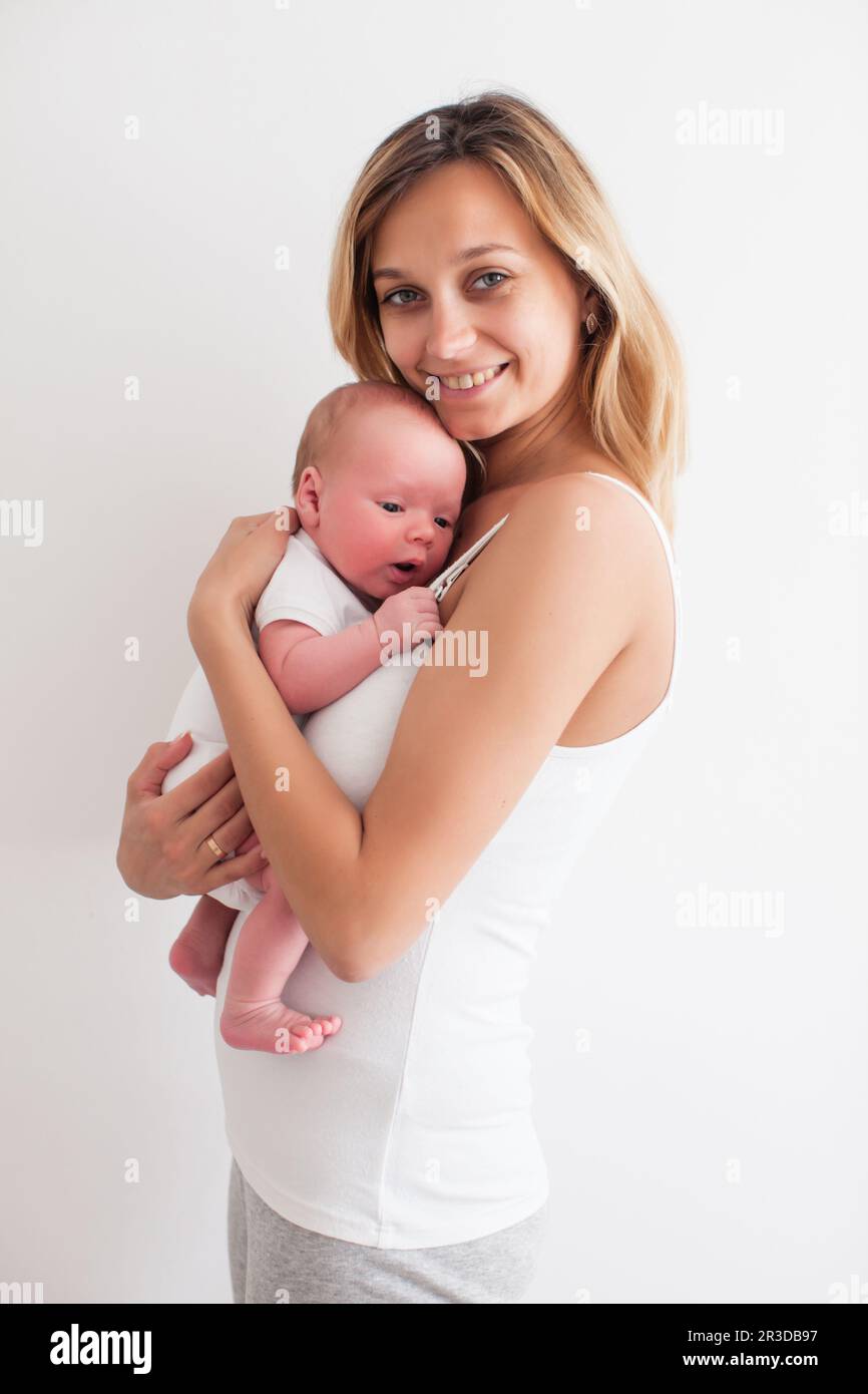 Pretty young smiling mother holding newborn baby Stock Photo - Alamy Pretty young smiling mother holding newborn baby Stock Photo - Alamy