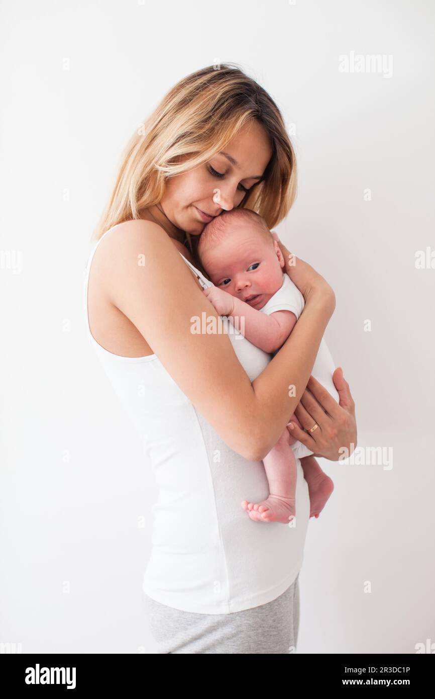 Pretty young smiling mother holding newborn baby Stock Photo - Alamy Pretty young smiling mother holding newborn baby Stock Photo - Alamy