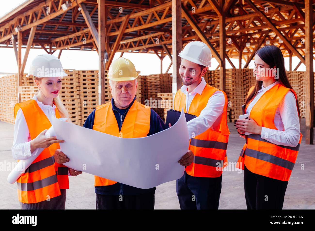 Senior engineer sharing experience with younger co-workers Stock Photo ...
