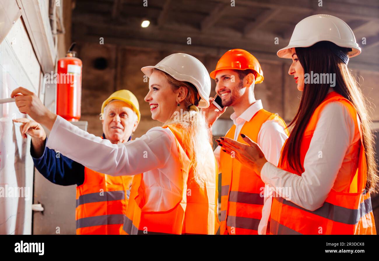 The workers draw up a plan of work at the plant Stock Photo - Alamy