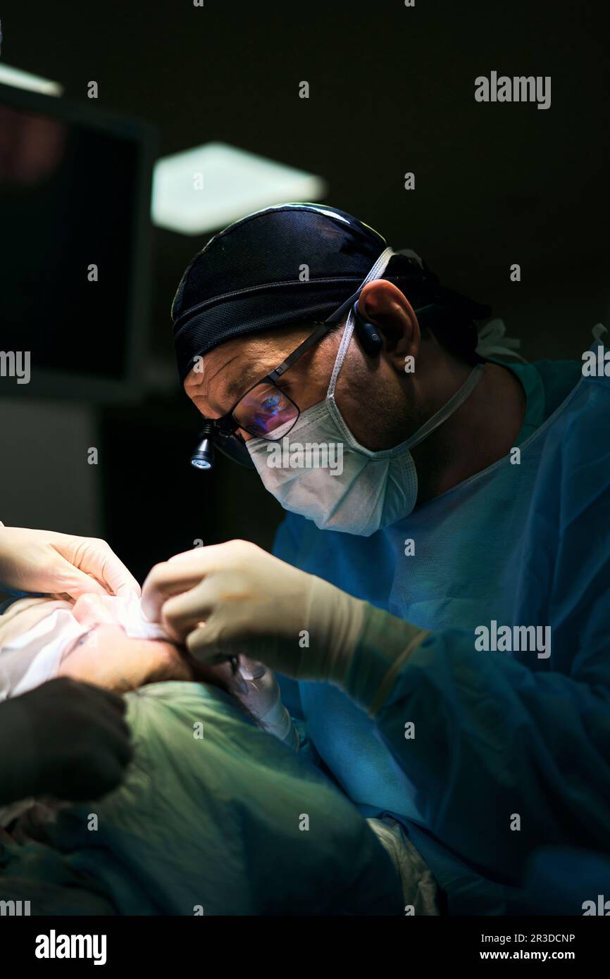 surgeon works in the operating room by the light of a lamp Stock Photo - Alamy