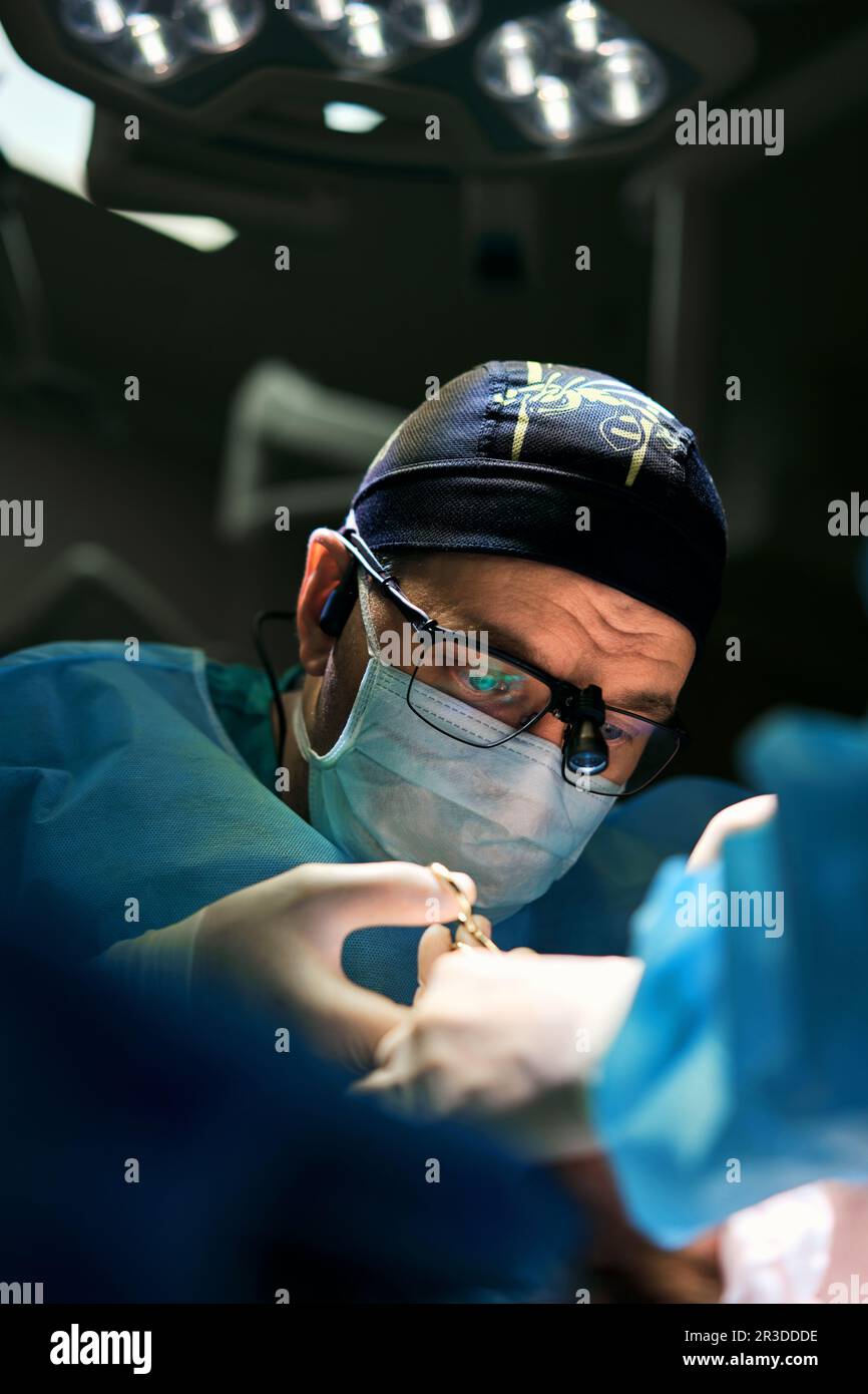 surgeon works in the operating room by the light of a lamp Stock Photo ...