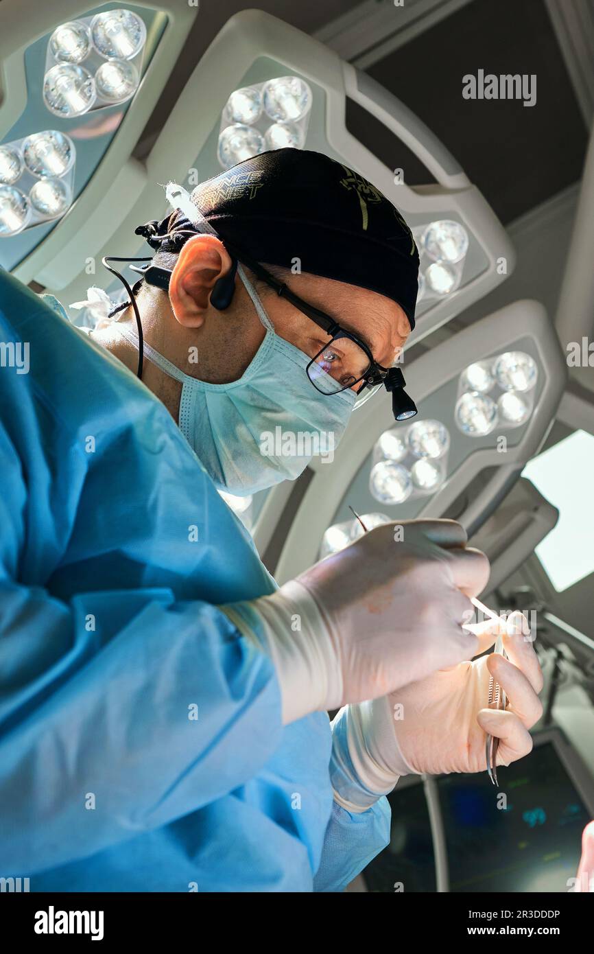 surgeon works in the operating room by the light of a lamp Stock Photo ...