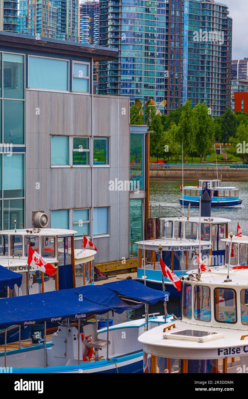 Floating homes and docked harbour ferries in False Creek Vancouver ...