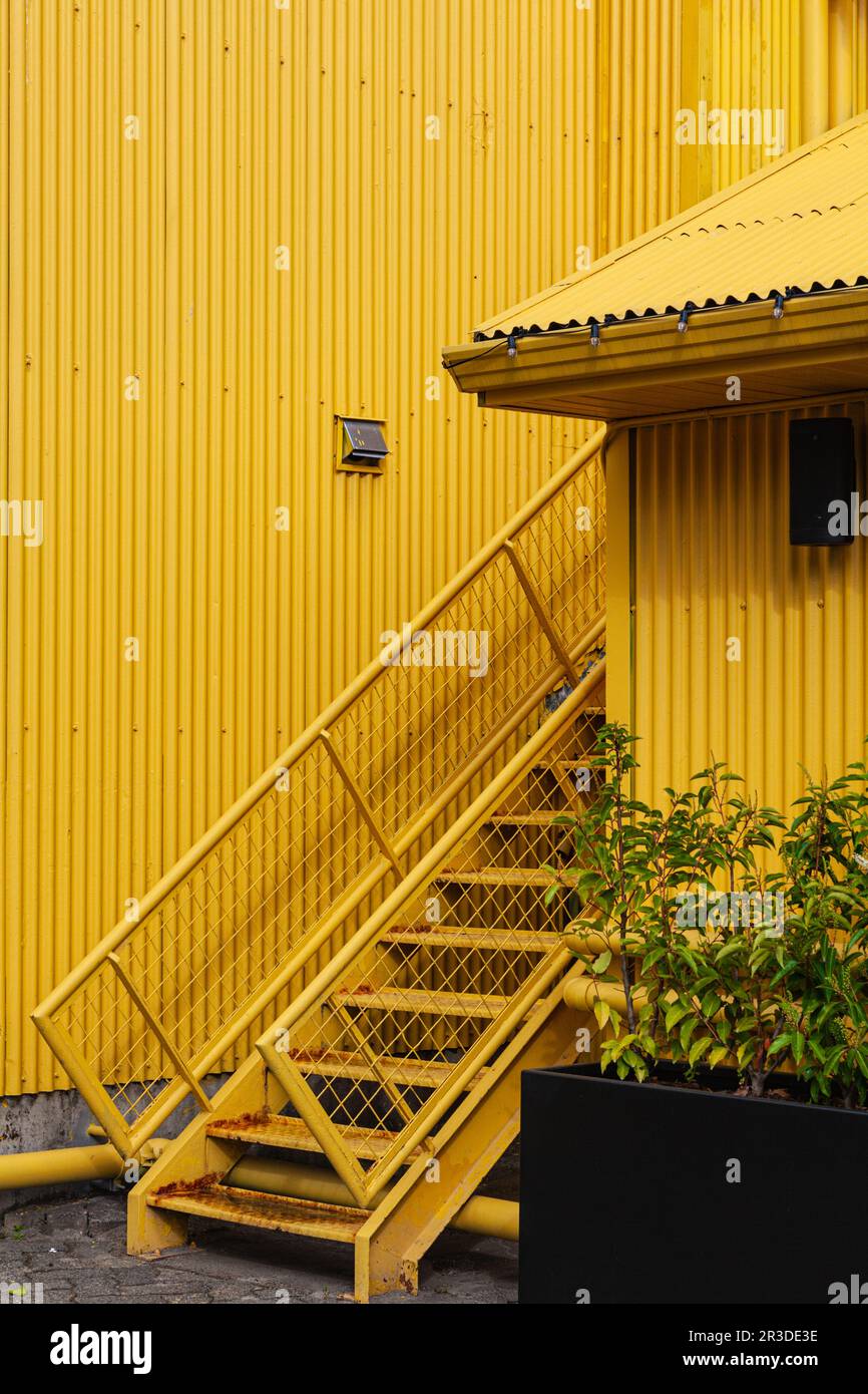 Exterior stairs on a yellow building on Granville Island in Vancouver ...