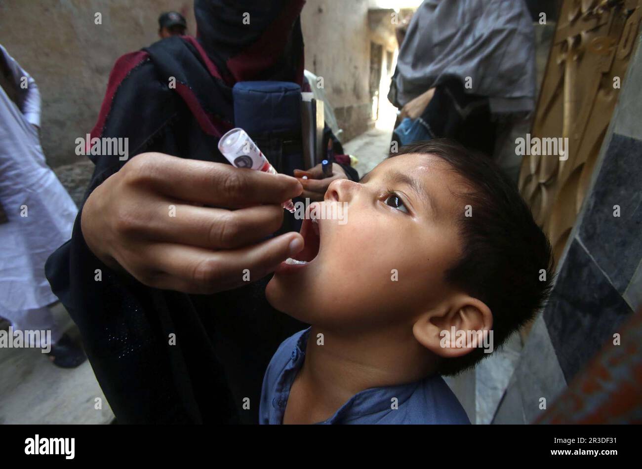 Karachi, Pakistan, May 23, 2023. Health worker administrates polio ...