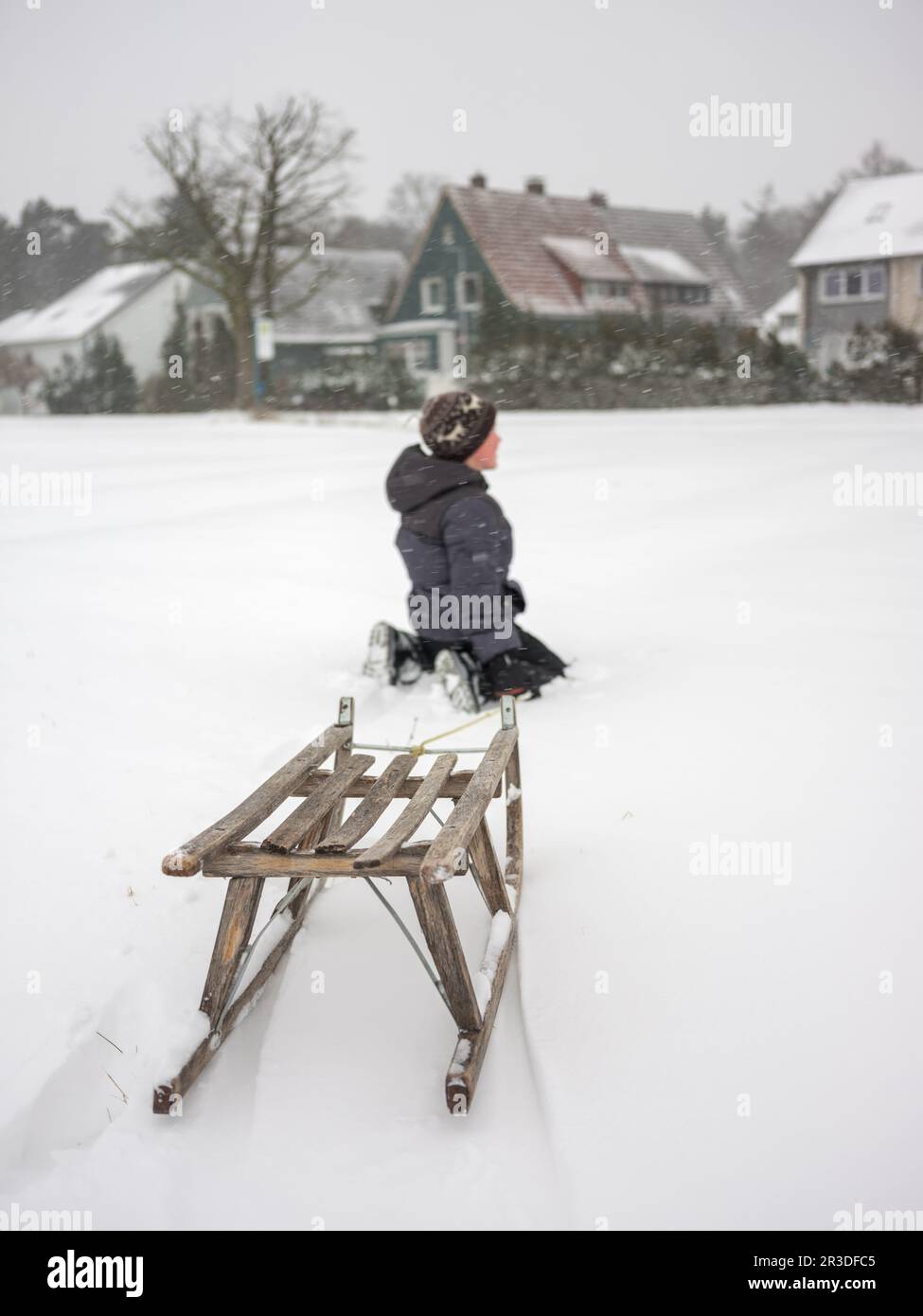 Boy with sled Stock Photo - Alamy