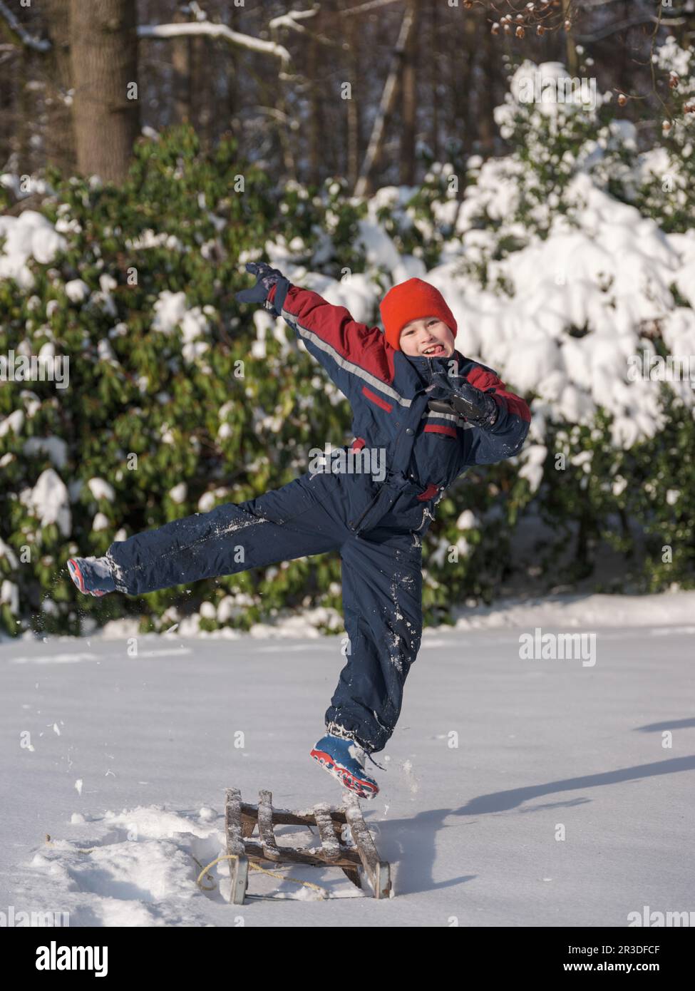 Boy jumps off a sled that stood still Stock Photo - Alamy