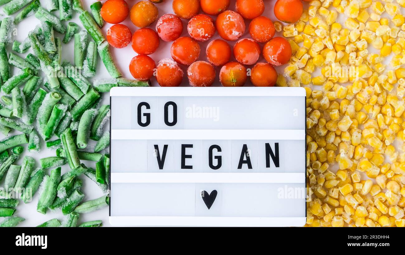 Lightbox with text GO VEGAN frozen vegetables food of yellow corn ...