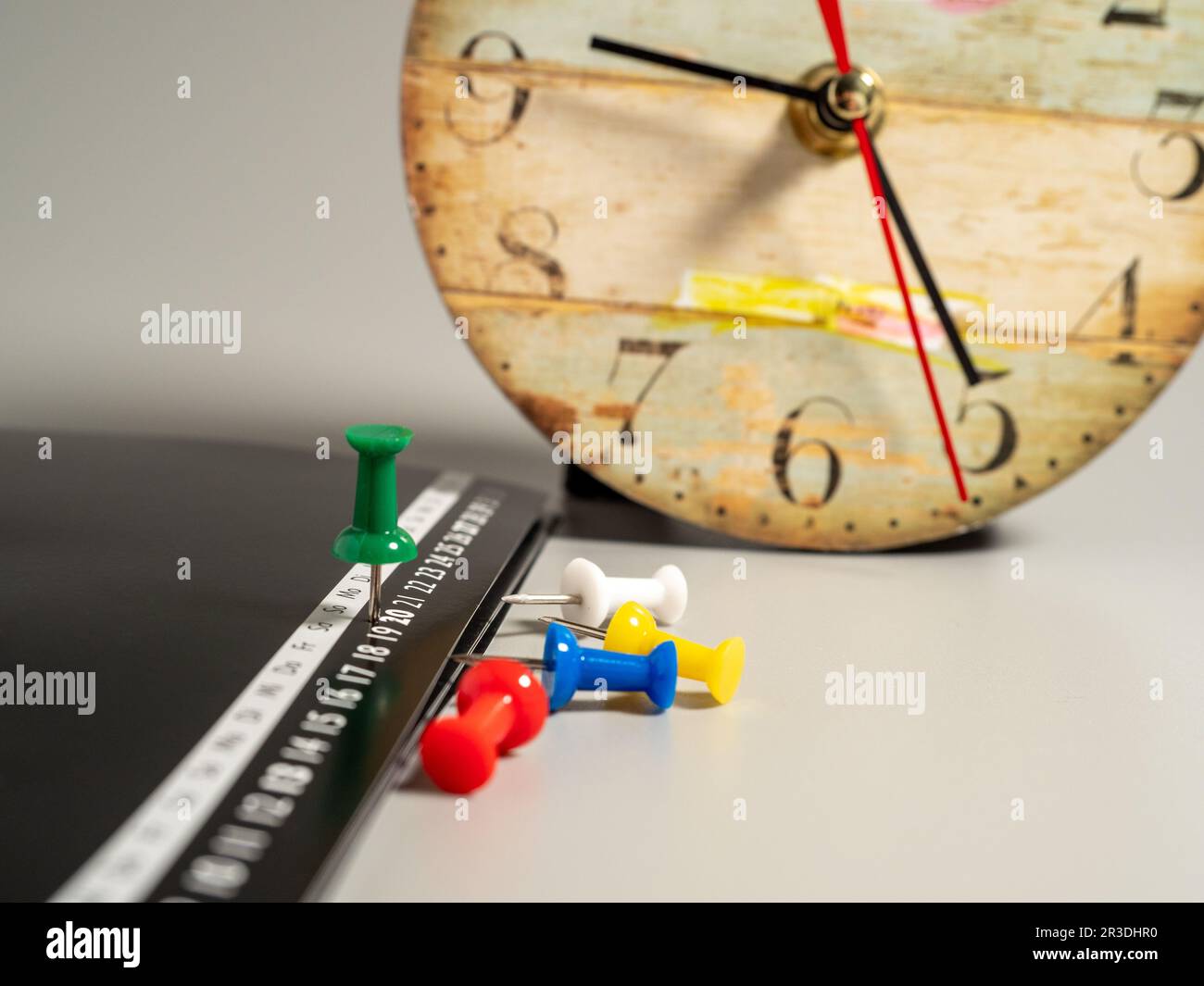 Close-up of retro clock and calendar with push pins. Time concept Stock ...