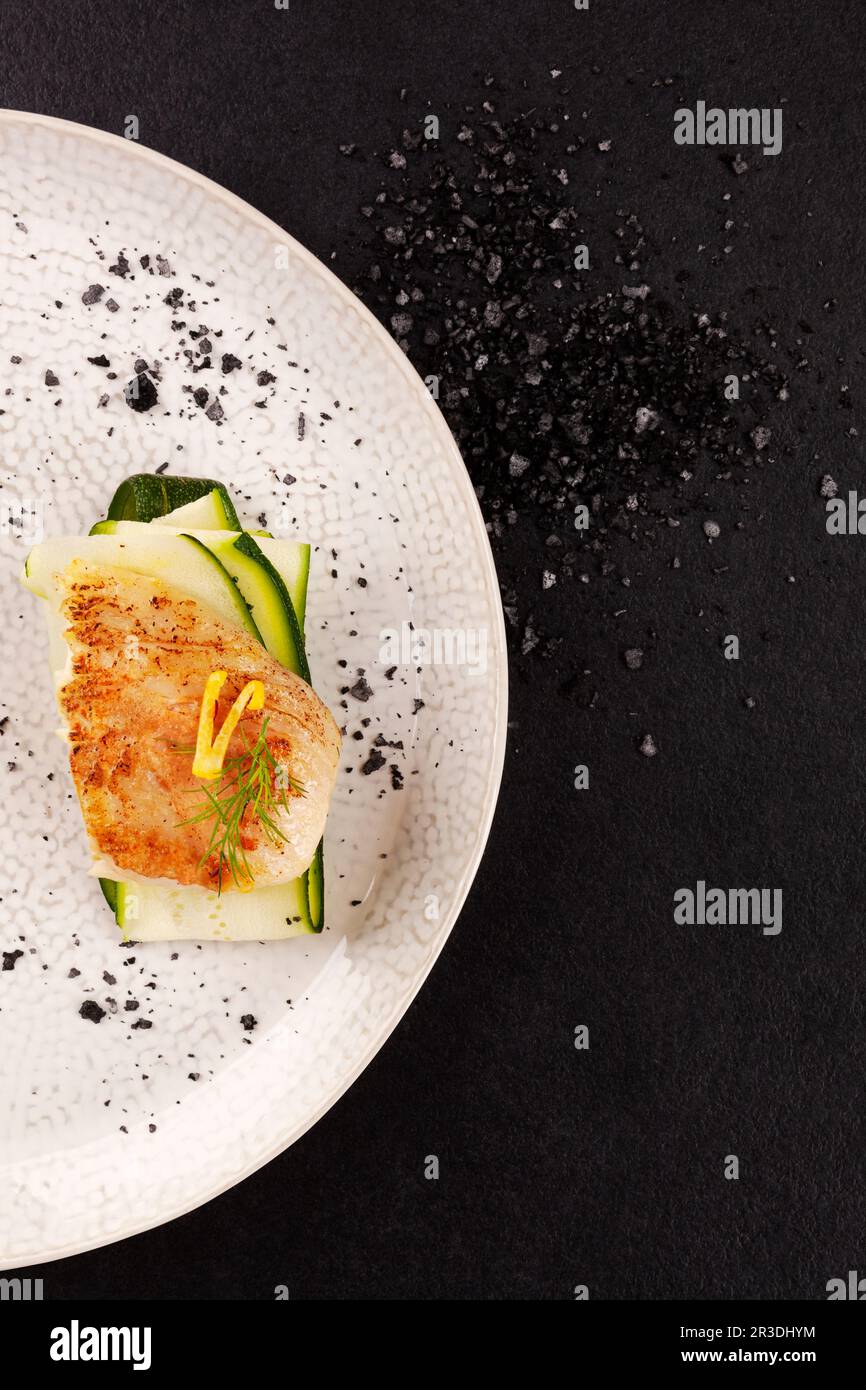 Luxurious seafood dinner. Perch fish fillet on zucchini slices Stock ...