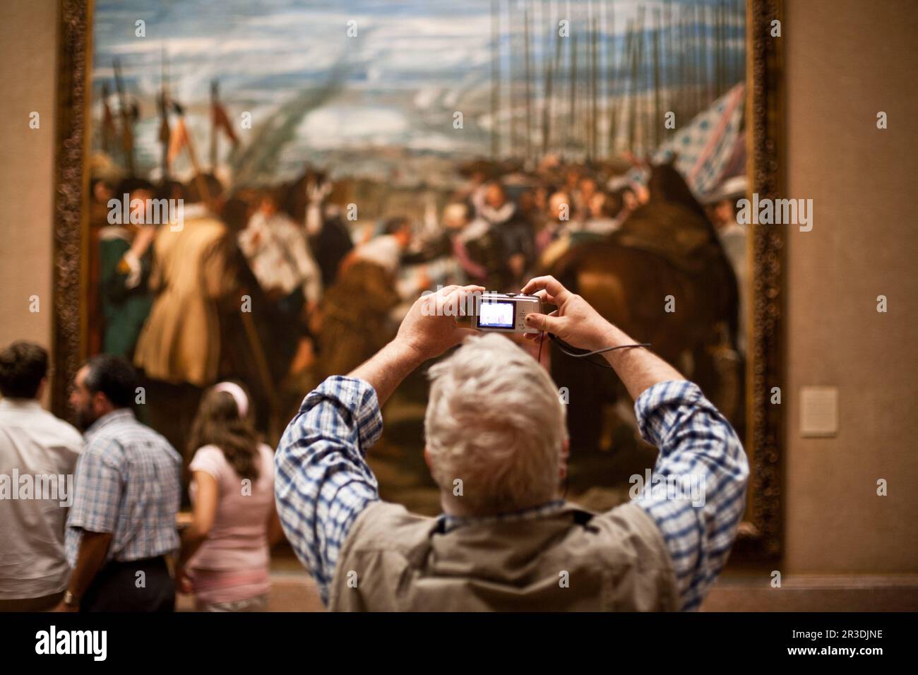 A tourist at the Prado Museum, taking a photo of the famous painting by ...