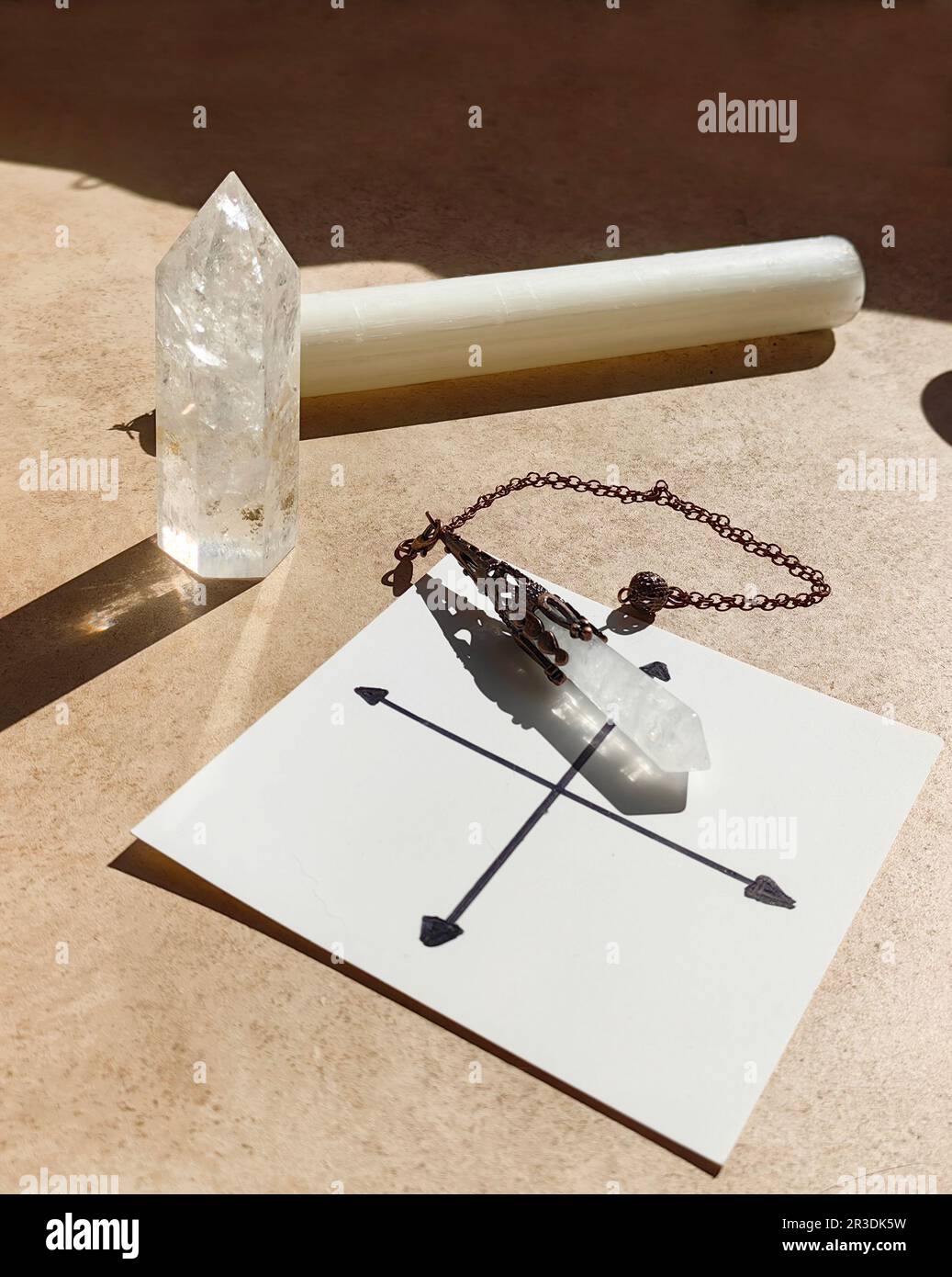 Gemstones for esoteric spiritual practice. Rock crystal pendulum on the ...