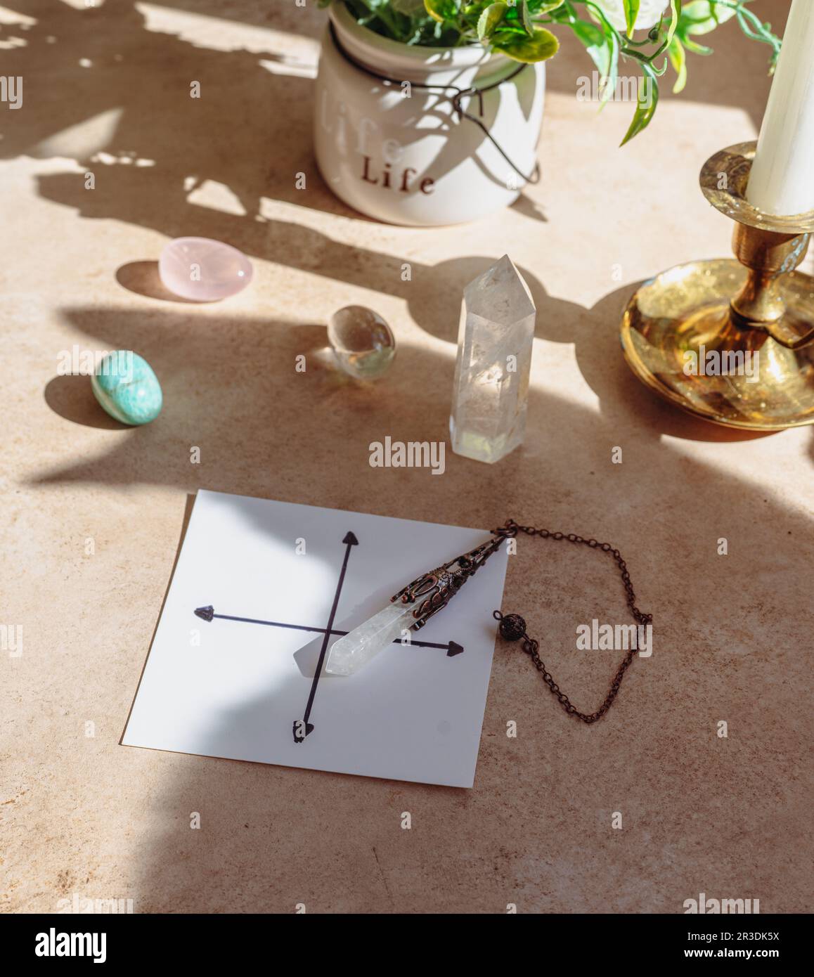 Gemstones for esoteric spiritual practice. Rock crystal pendulum on the ...