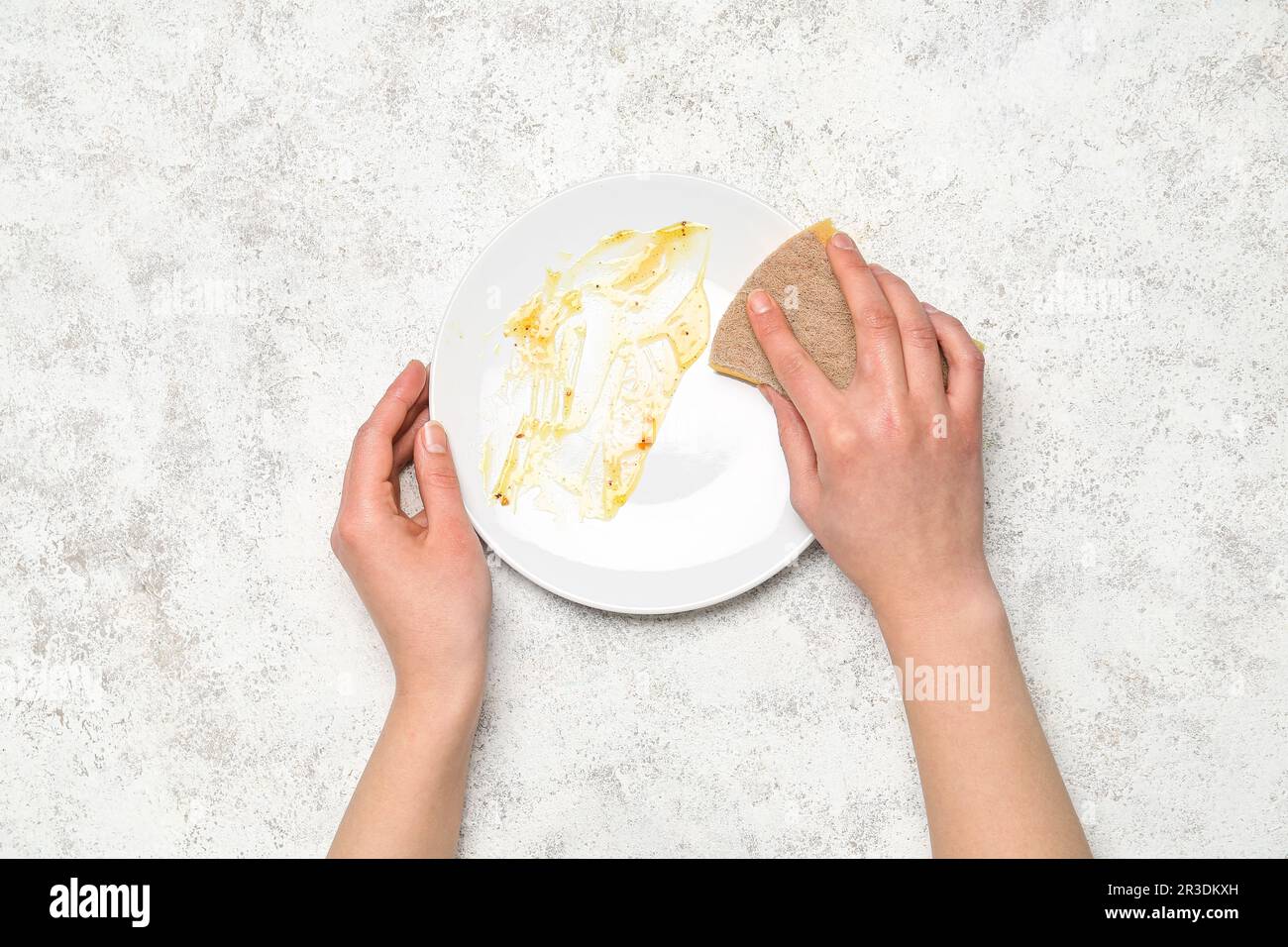 Woman washing dirty plate on white grunge background Stock Photo - Alamy
