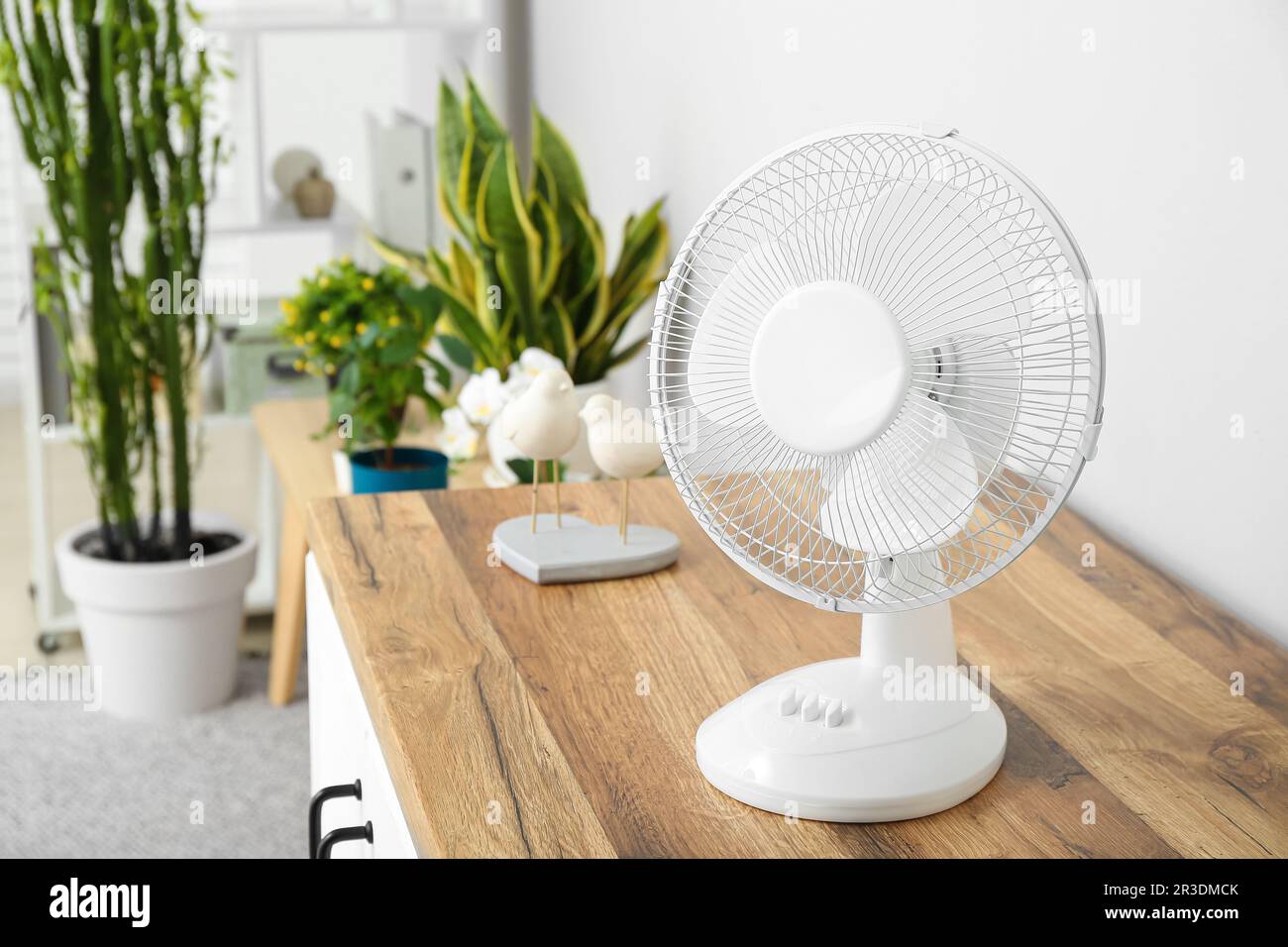 Modern electric fan on table in living room Stock Photo - Alamy