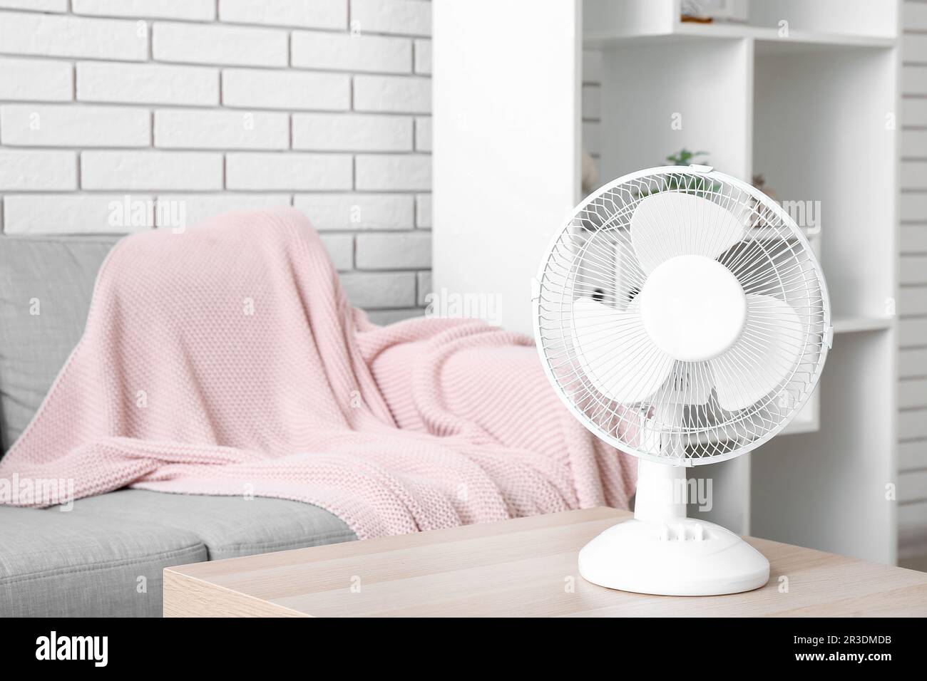 Modern electric fan on table in living room Stock Photo - Alamy