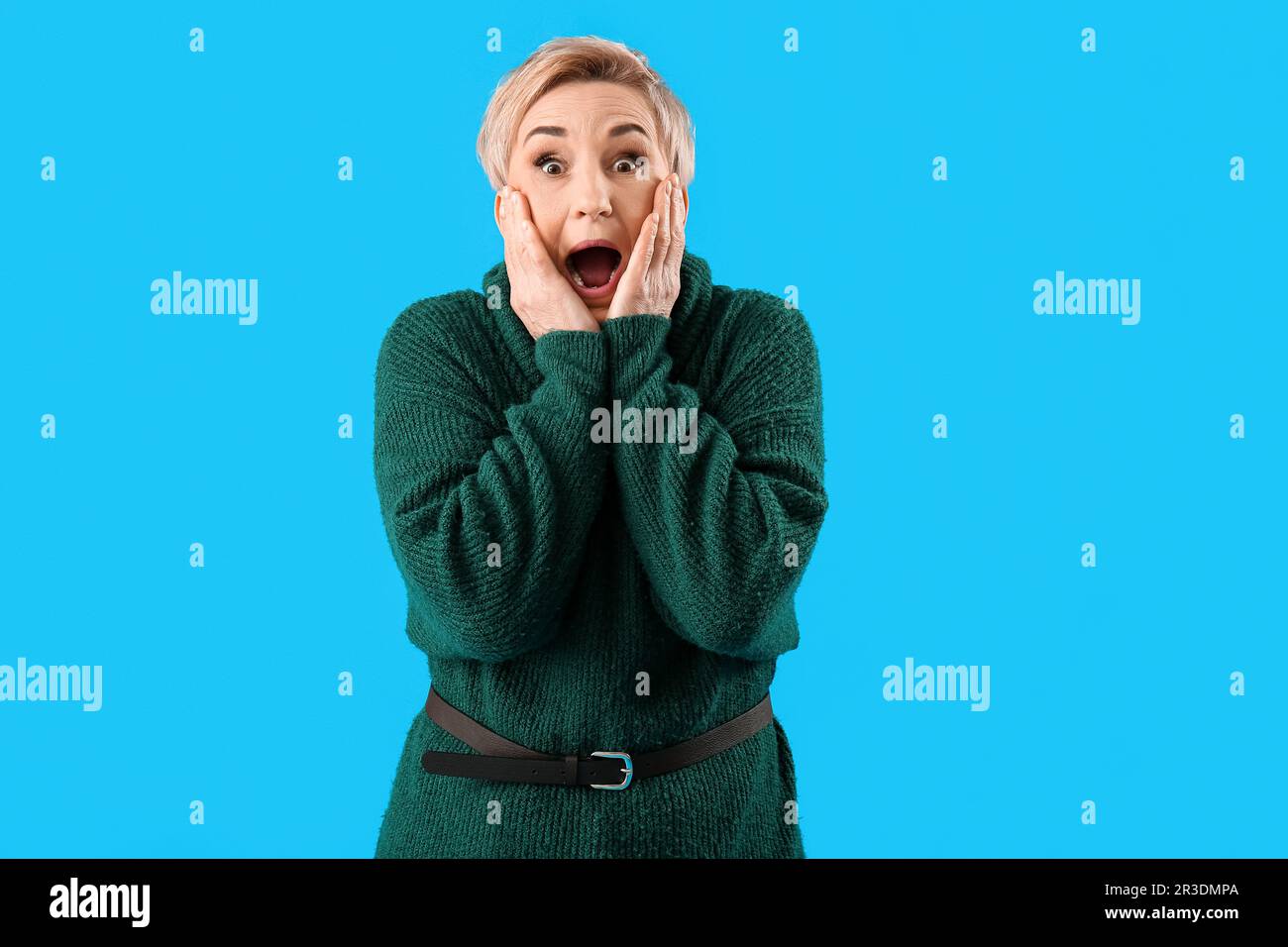 Screaming scared mature woman on light blue background Stock Photo - Alamy