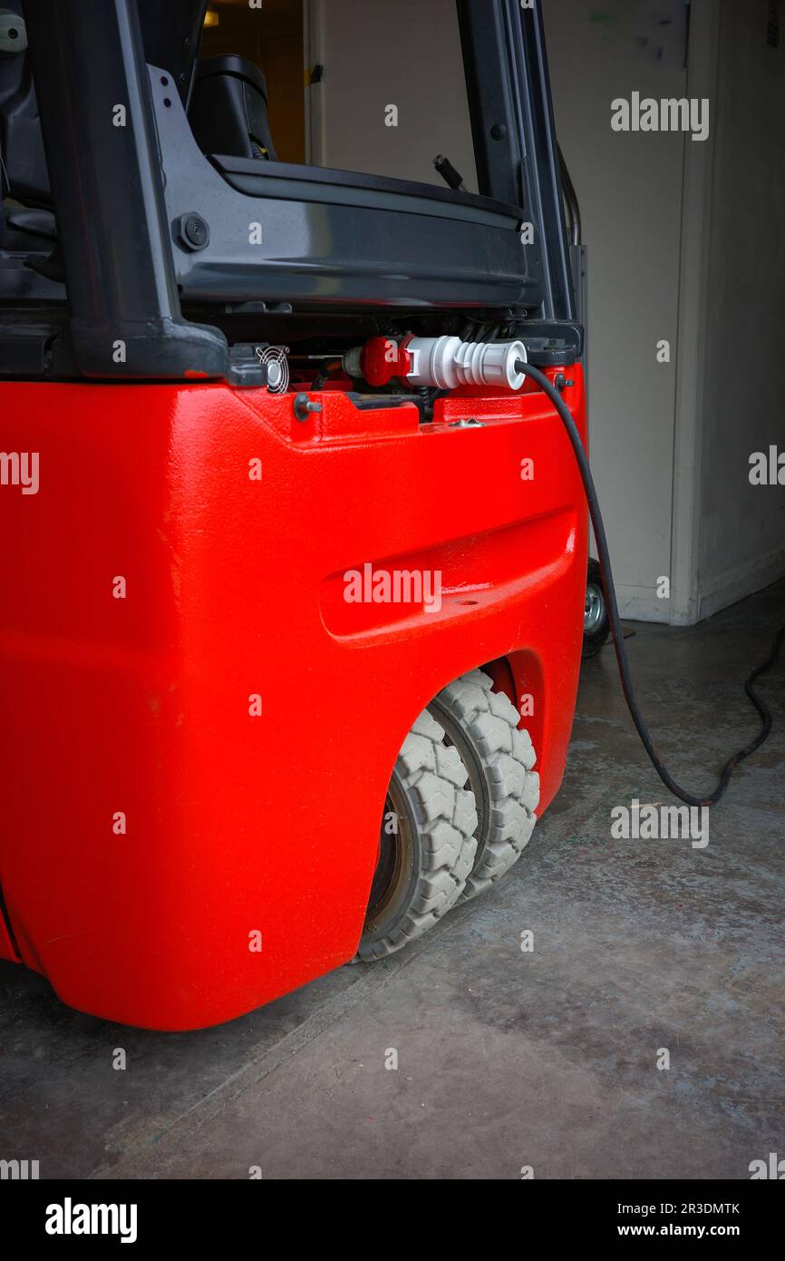 Fork lift truck with electric cable plugged in for recharging the ...