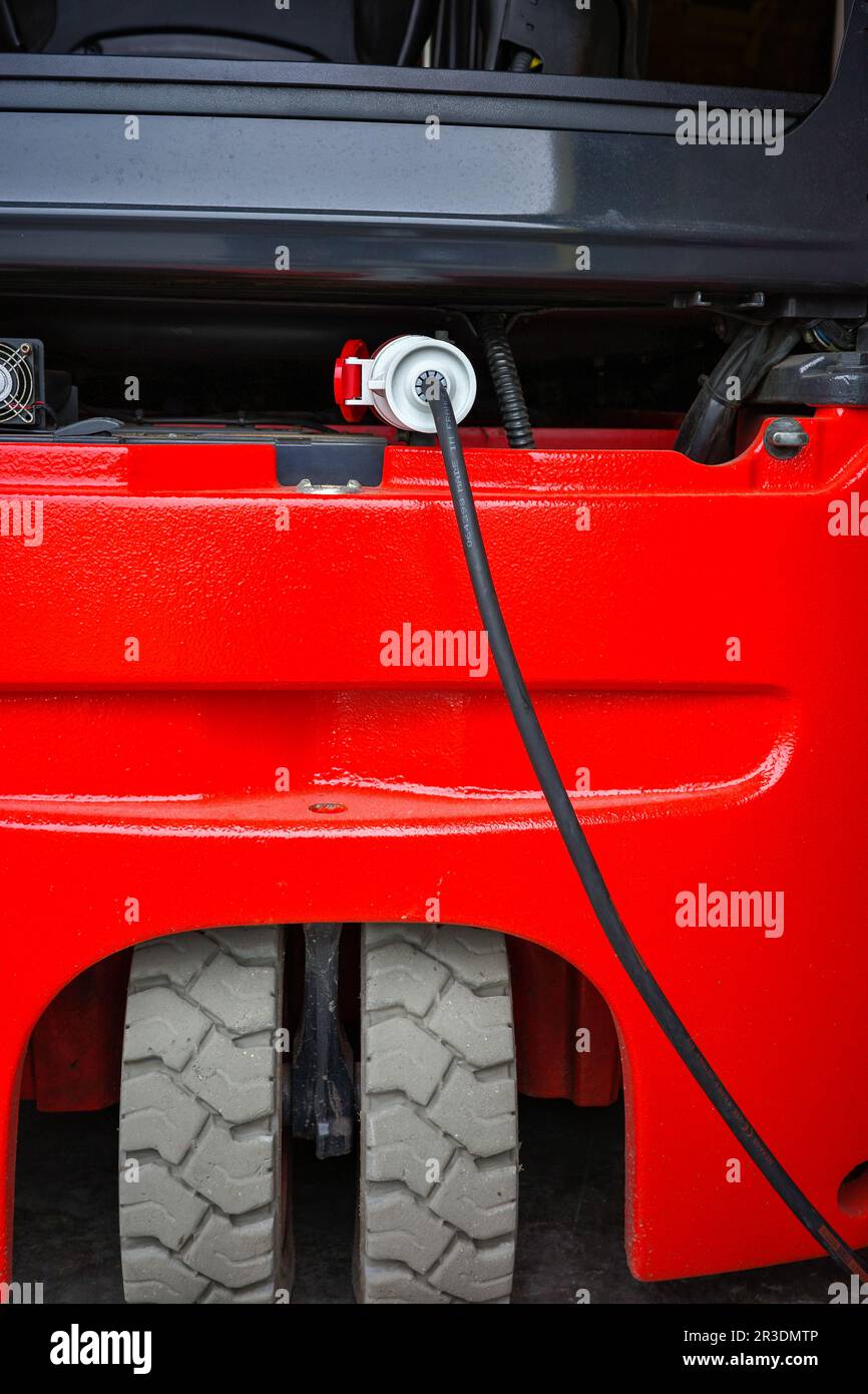 Fork lift truck with electric cable plugged in for recharging the ...