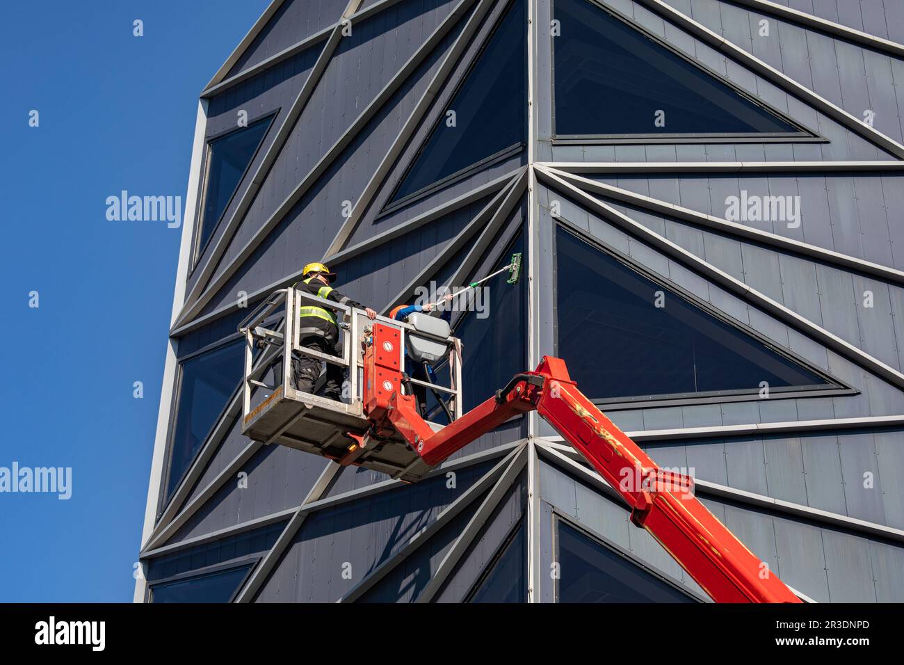 Window cleaning crew on articulating boom lift at Rotermanni Quarter in ...