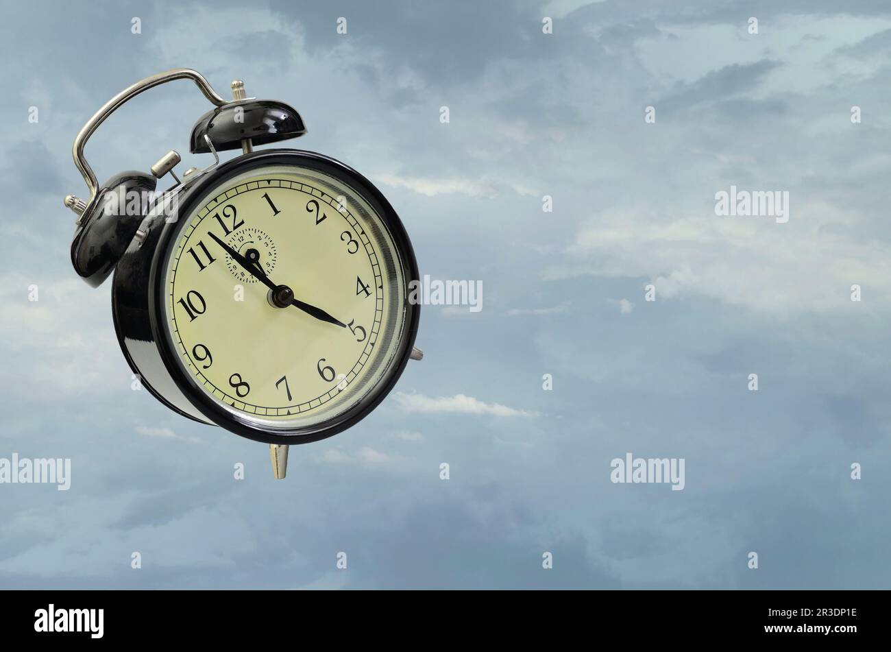 Alarm clock floating in the air Stock Photo - Alamy