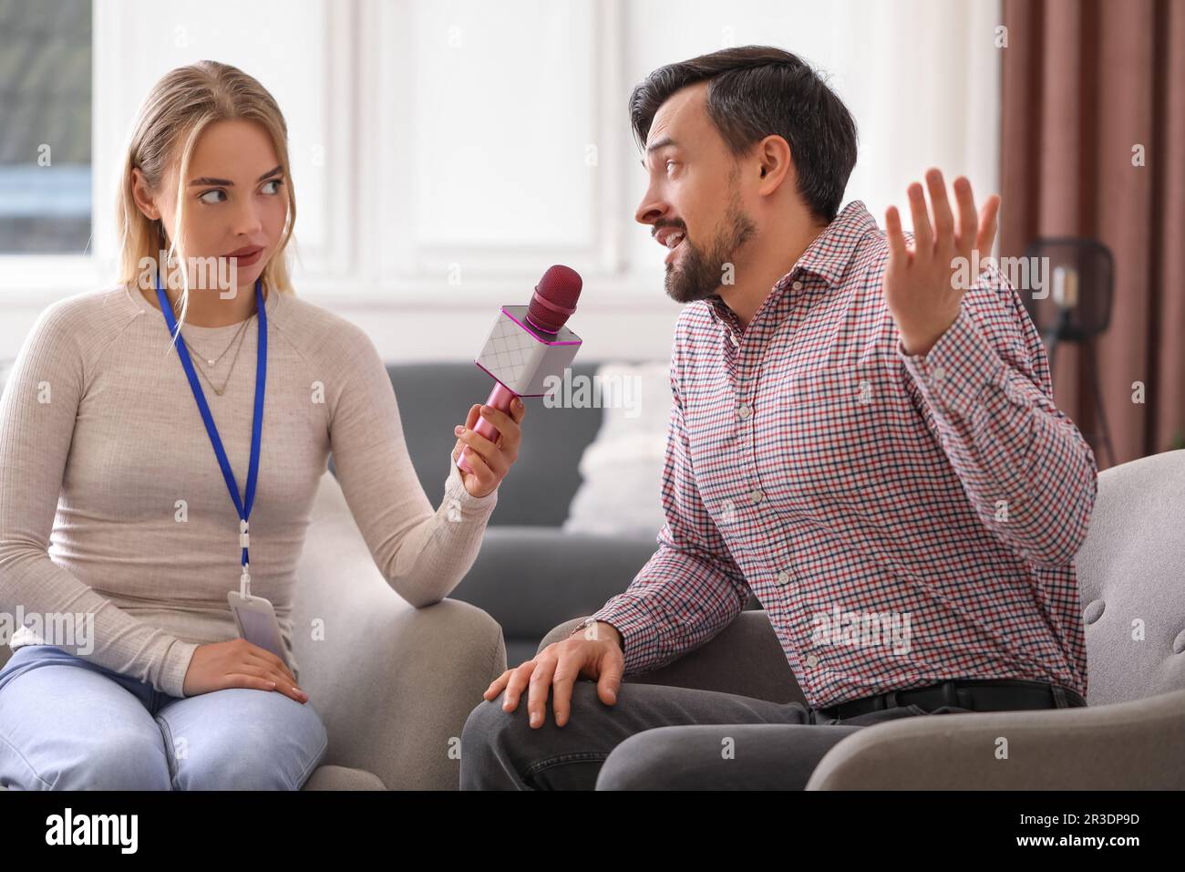 Female journalist with microphone having an interview with man in ...