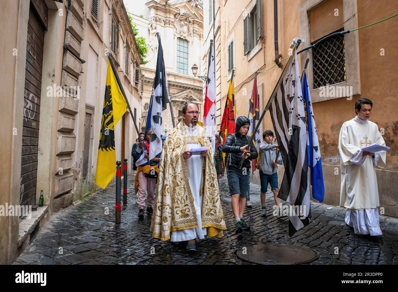A priest his habit full of golden ornaments surrounded by flags with ...