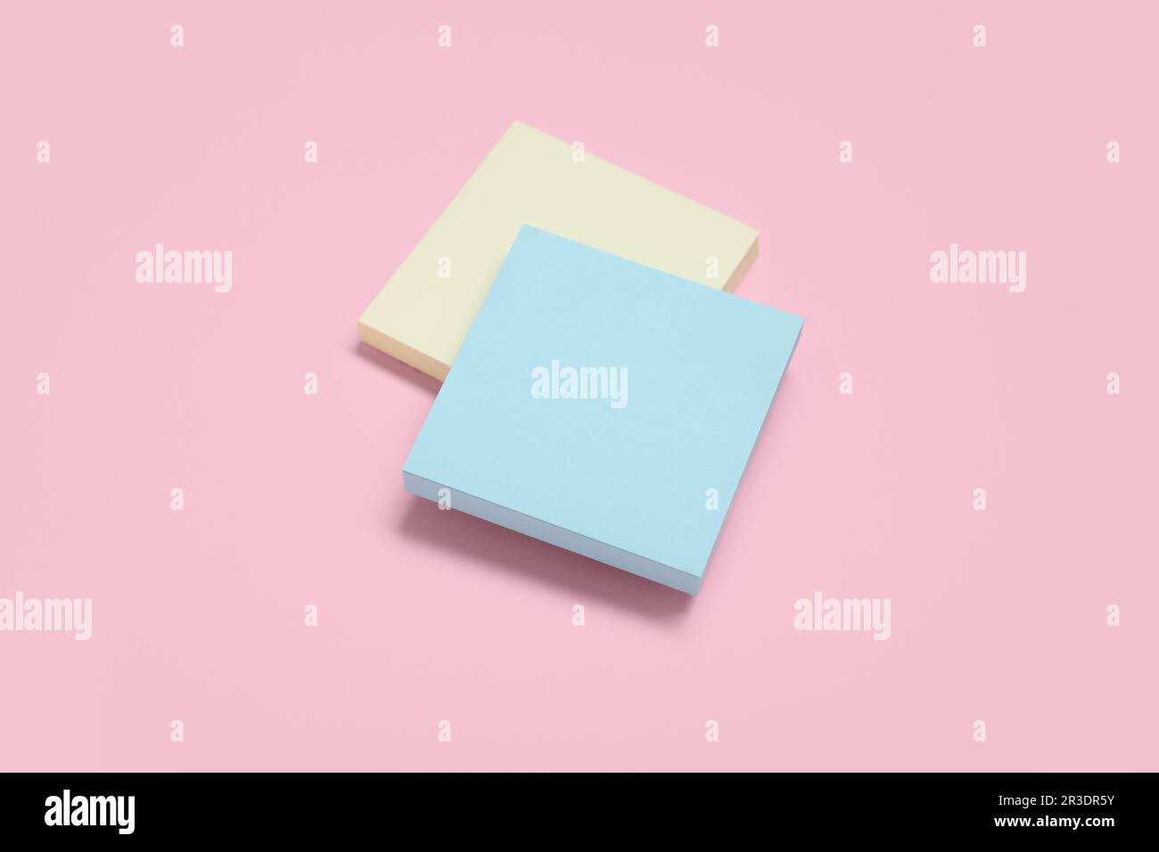 Sticky notes on pale pink background Stock Photo - Alamy