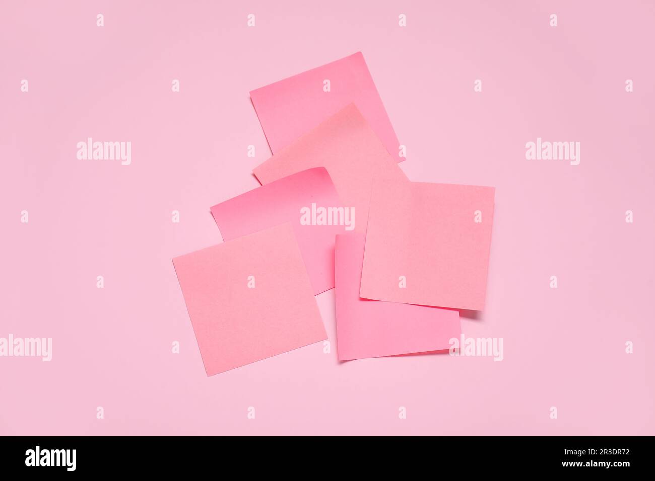 Sticky notes on pale pink background Stock Photo - Alamy