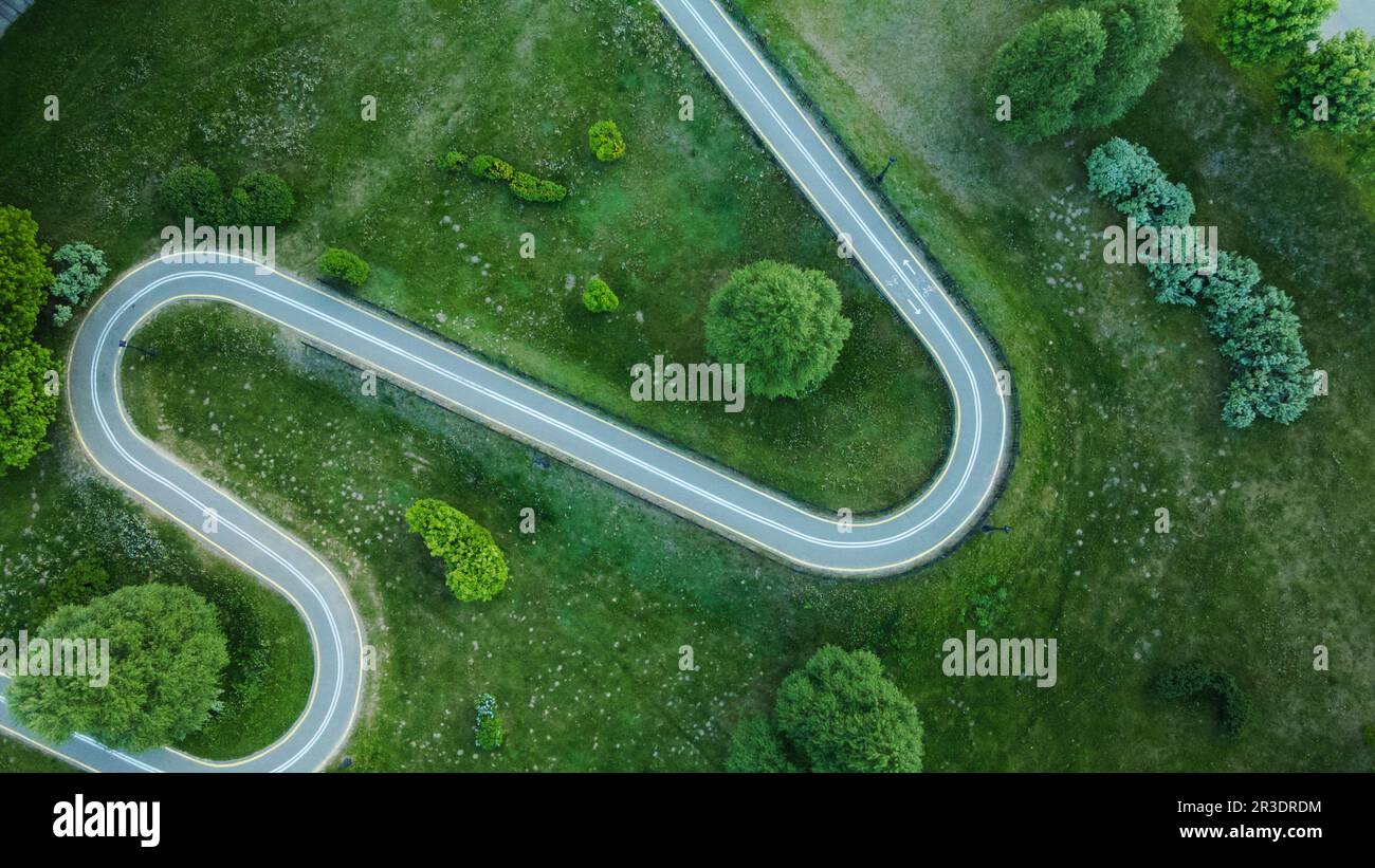 Curvy bike path. Laid between the trees in the park. Drone photography ...