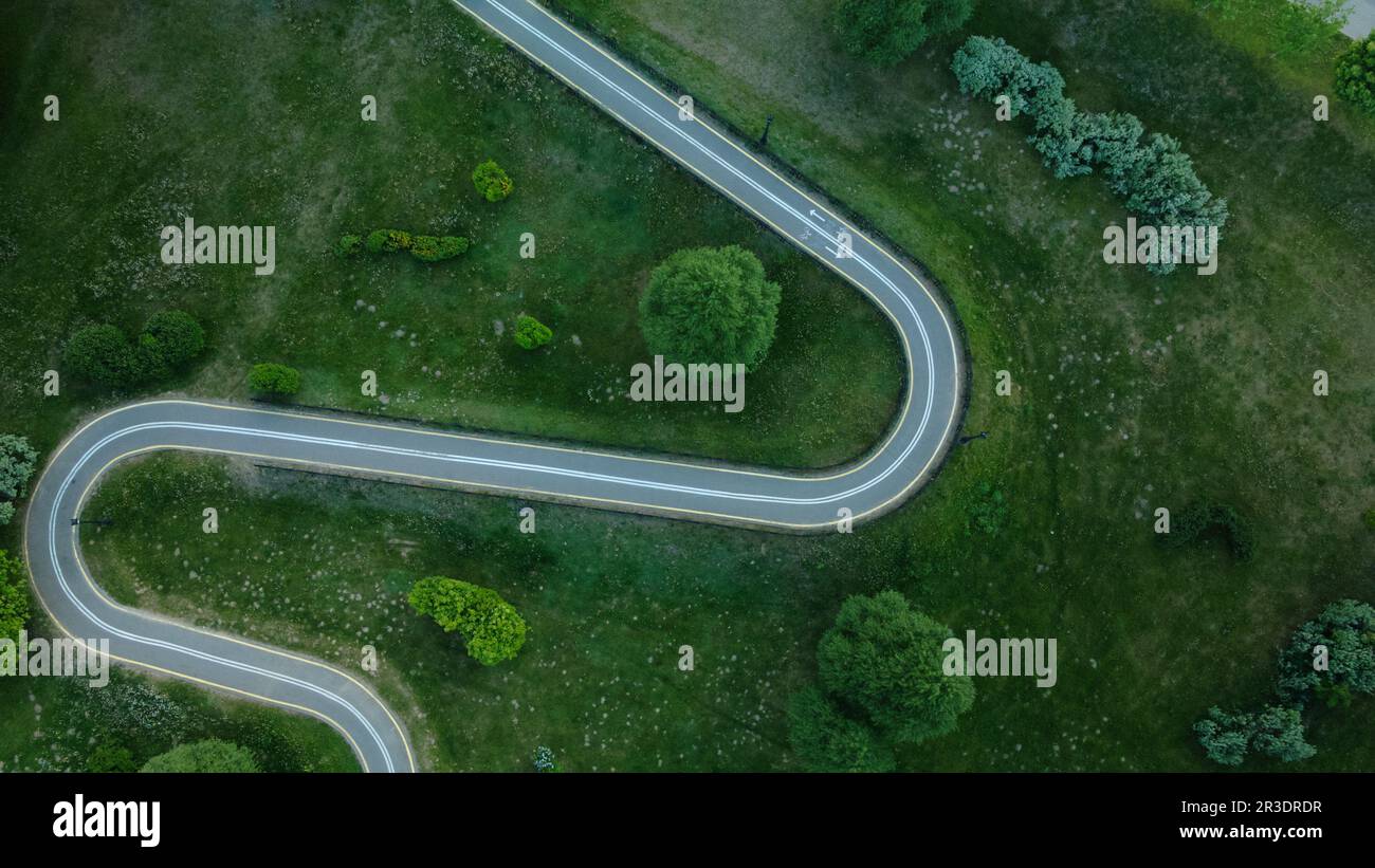 Curvy bike path. Laid between the trees in the park. Drone photography ...