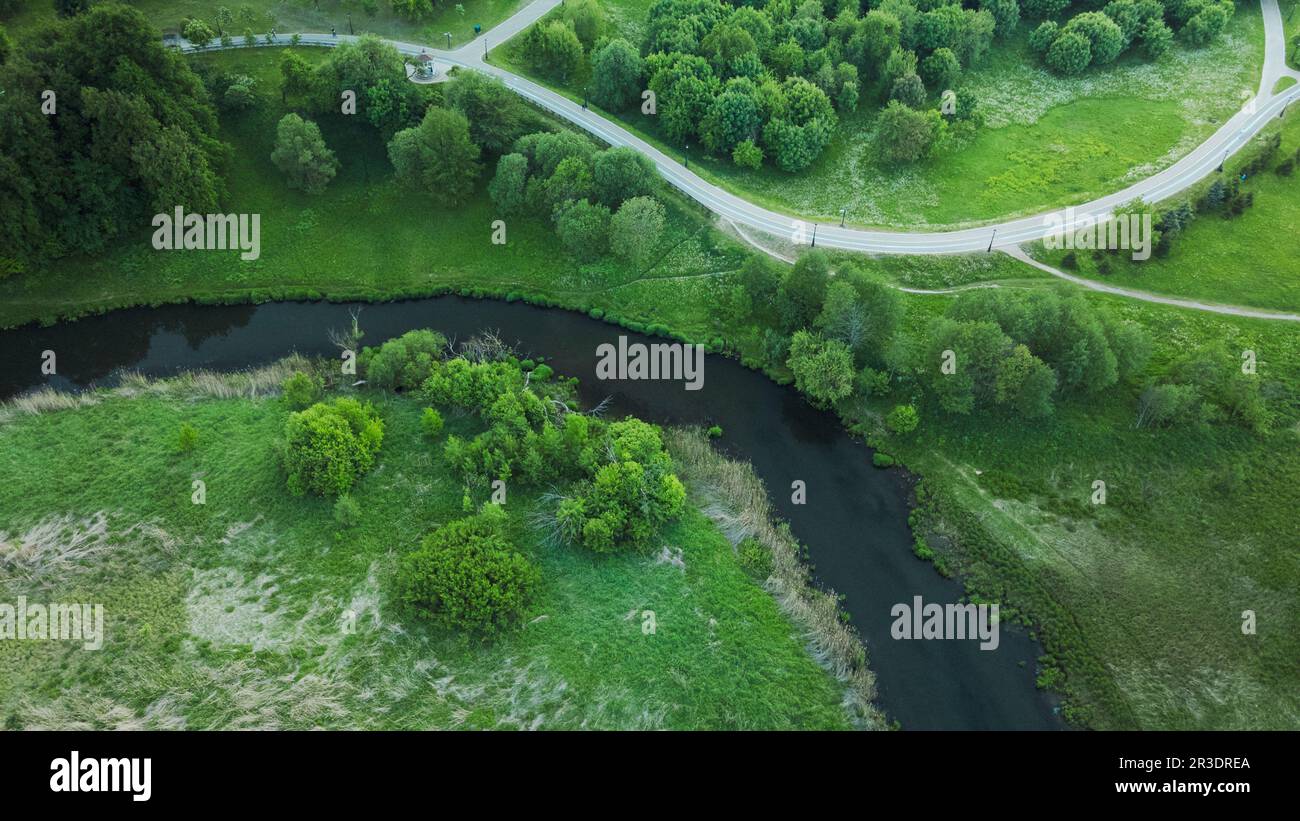 Curvy bike path. Laid between the trees in the park. Drone photography ...