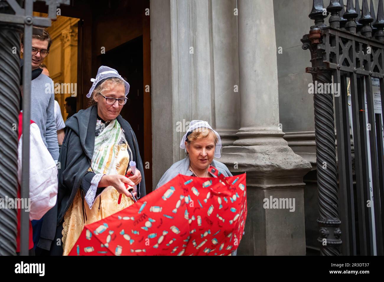 Women dressed in historical French clothing exit the church of Sant'Ivo ...