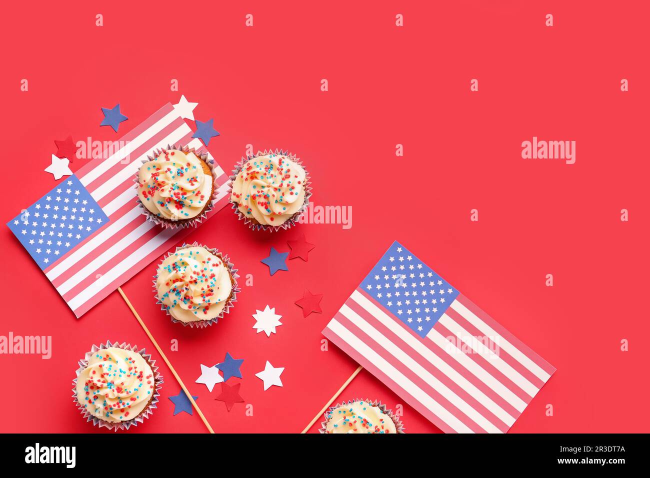 Tasty patriotic cupcakes with flags of USA on red background. American ...