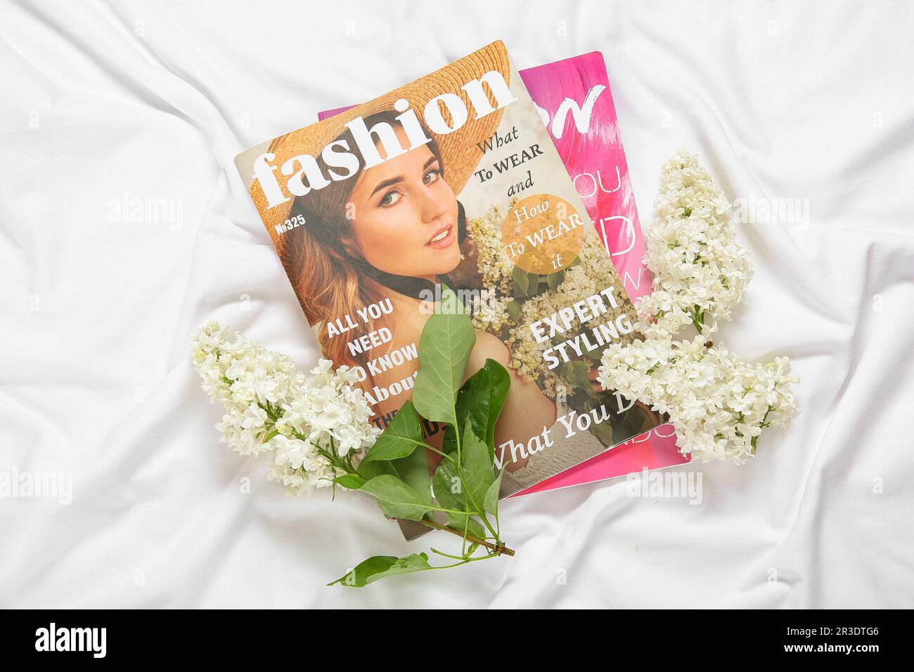 Beautiful blooming lilac flowers with magazines on bed Stock Photo - Alamy