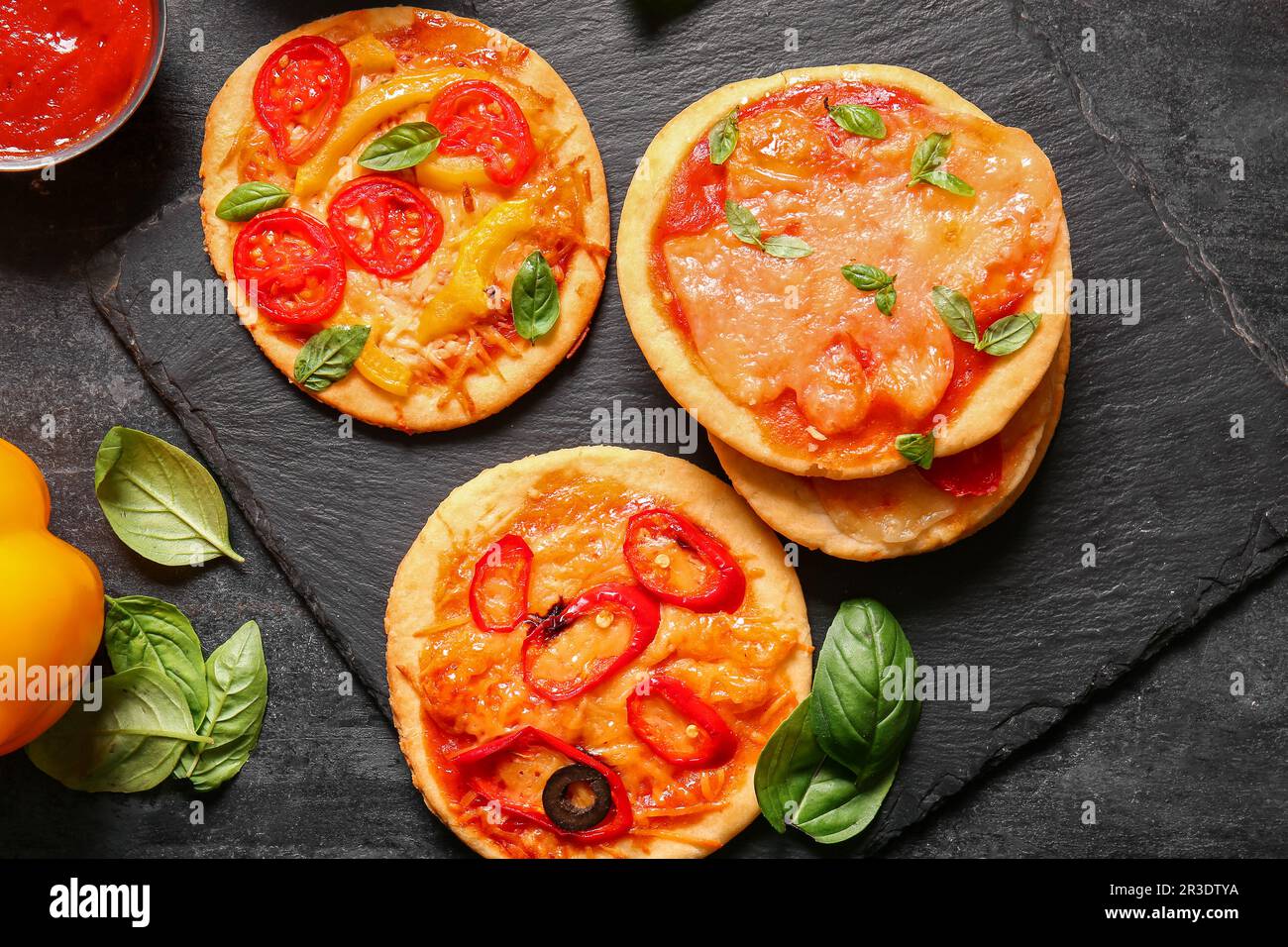 Board with different tasty mini pizzas on black background Stock Photo ...