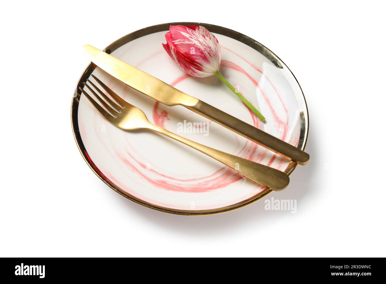 Simple table setting with cutlery and tulip flower in plate on white ...
