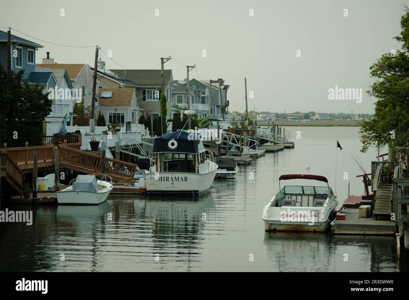 Canal with house and boats in Long Beach, New York Stock Photo - Alamy