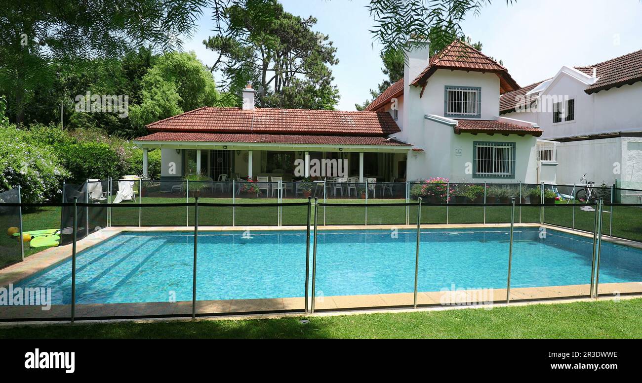 House exterior during sunny day. Residential home with swimming pool ...
