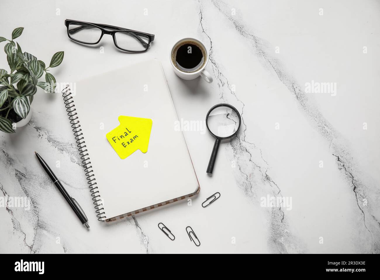 Sticky note with text FINAL EXAM, notebook, magnifier and cup of coffee ...