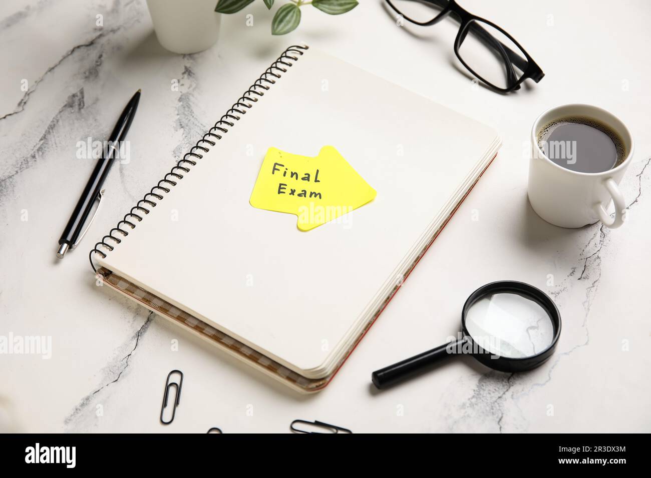 Sticky note with text FINAL EXAM, notebook, magnifier and cup of coffee ...