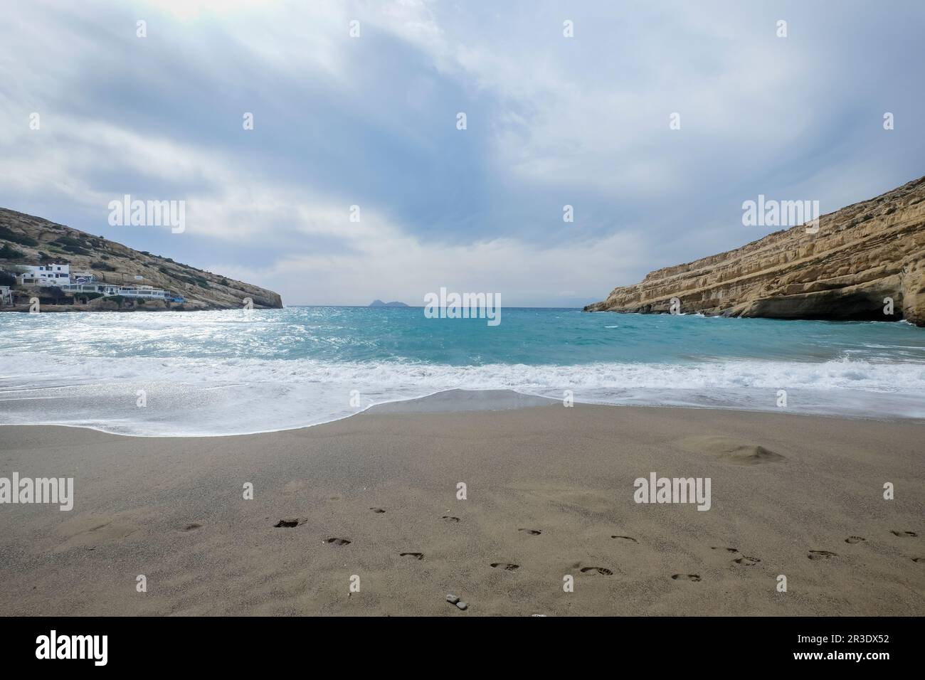 Panorama of Matala beach with the caves on the rocks that were used as ...